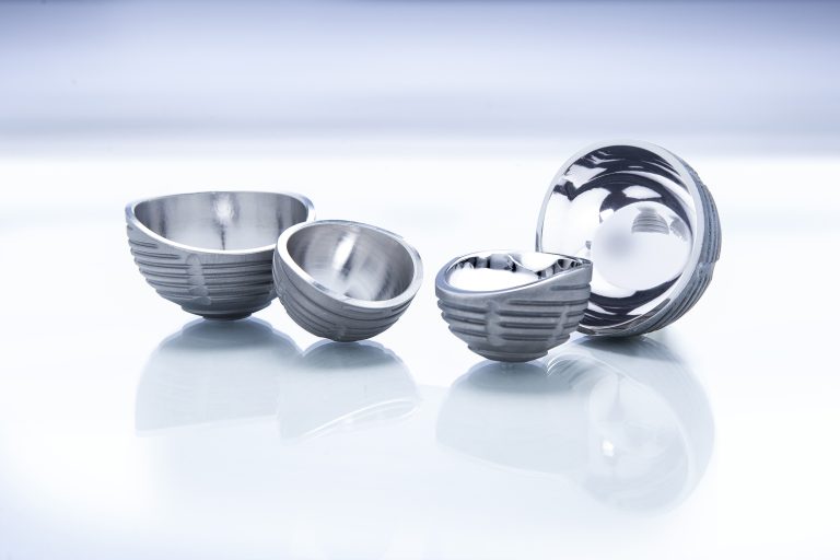 Cost-effective surface finishing of acetabular cups in a rotary…
